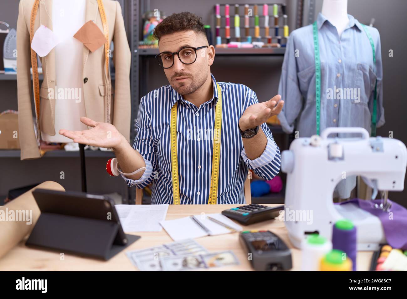 Hispanic man with beard dressmaker designer working at atelier clueless ...
