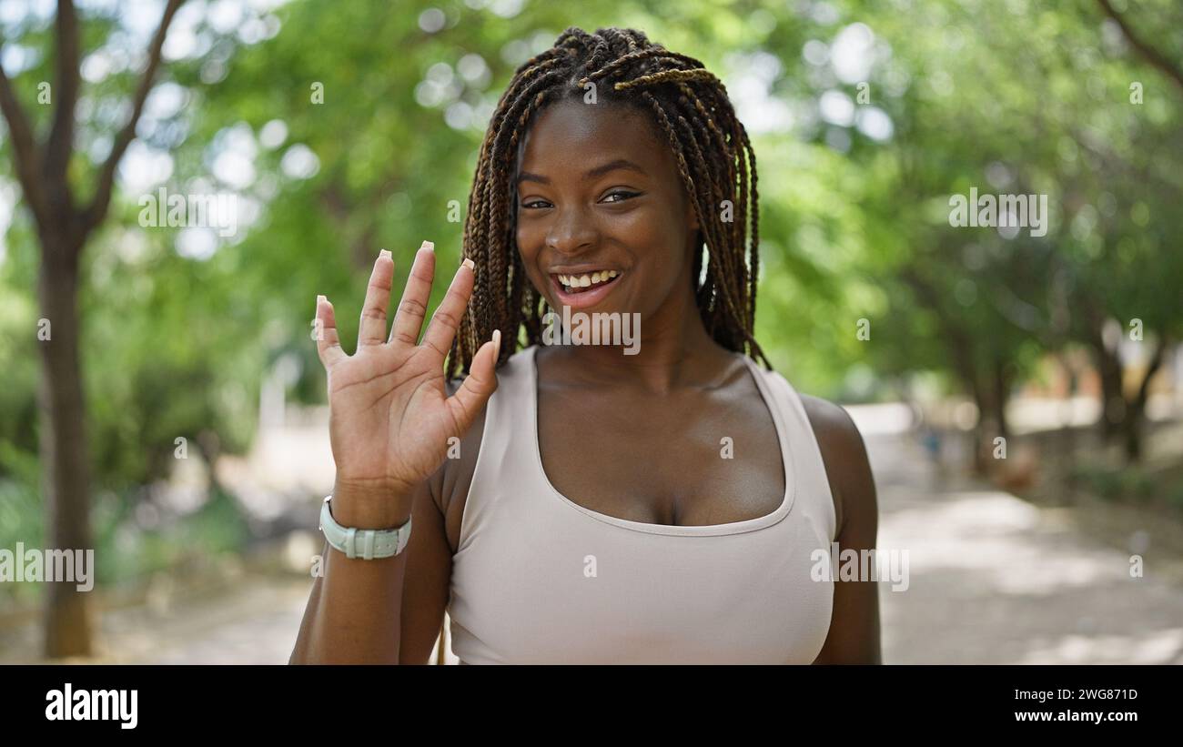 African American Woman Smiling Confident Saying Hello With Hand At Park