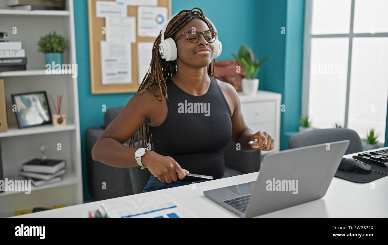 African american woman business worker listening to music doing drummer ...