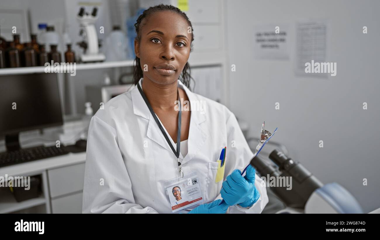 African american scientist woman with id card holding syringe in ...