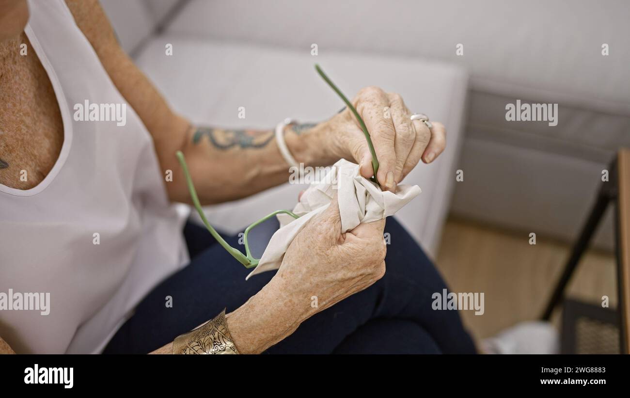 Relaxed senior woman comfortably sitting on a cozy sofa at home ...