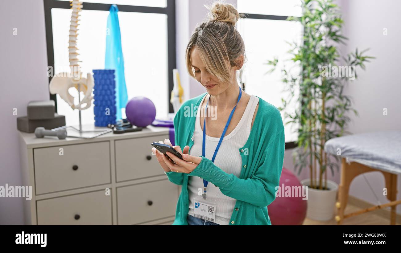 A young blonde woman working in a rehab clinic, wearing a badge, uses a ...