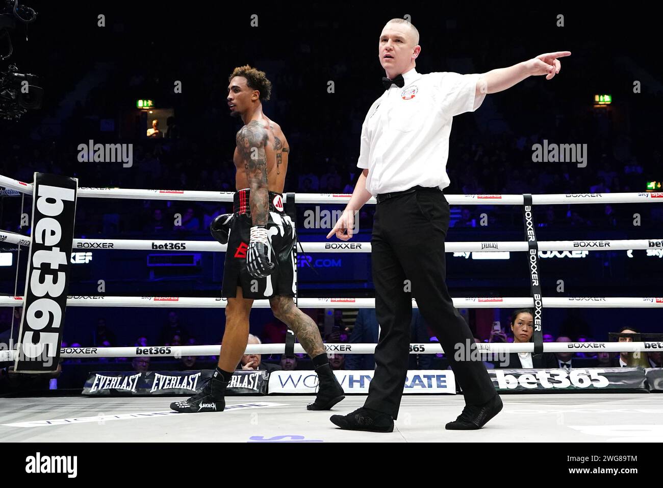 Ben Whittaker (left) is spoken to by the ring referee in the light ...