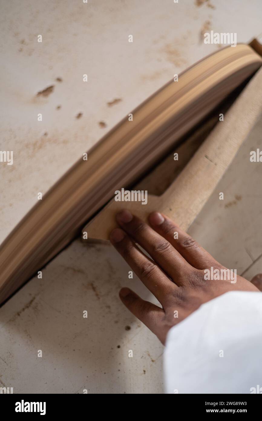 carpentry, hands of person with piece of wood sanding on industrial ...