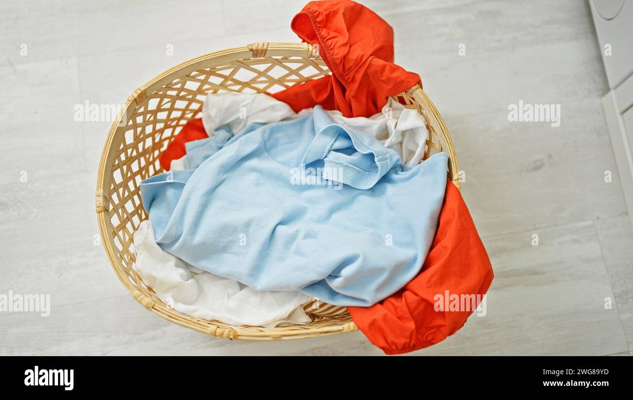 African american woman throwing clothes on basket at laundry room Stock ...