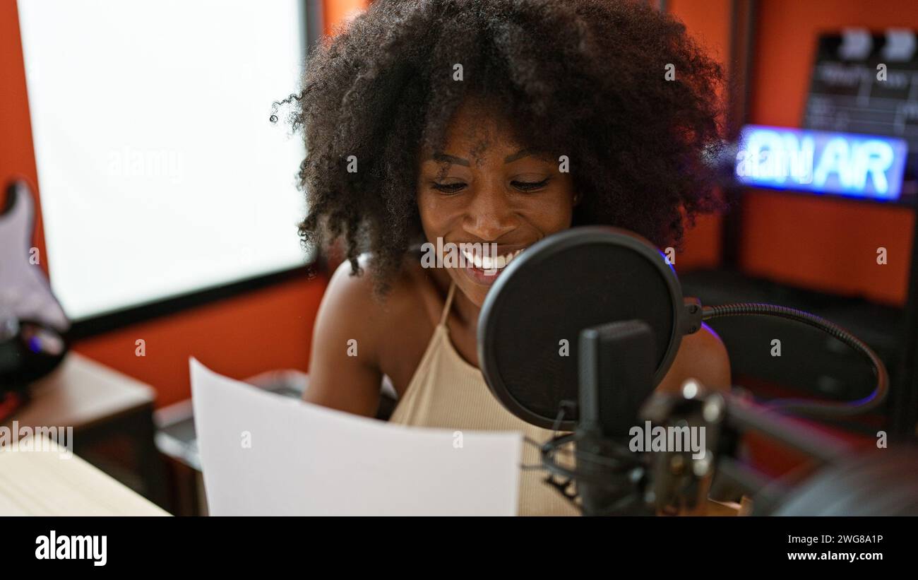 African american woman radio reporter reading script working at radio ...