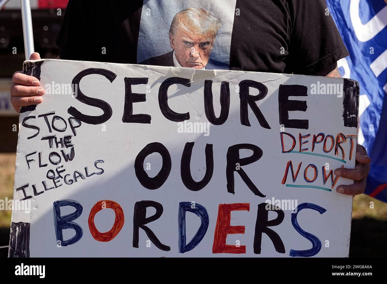 Phill Cady holds a sign during a "Take Our Border Back" rally, Saturday ...