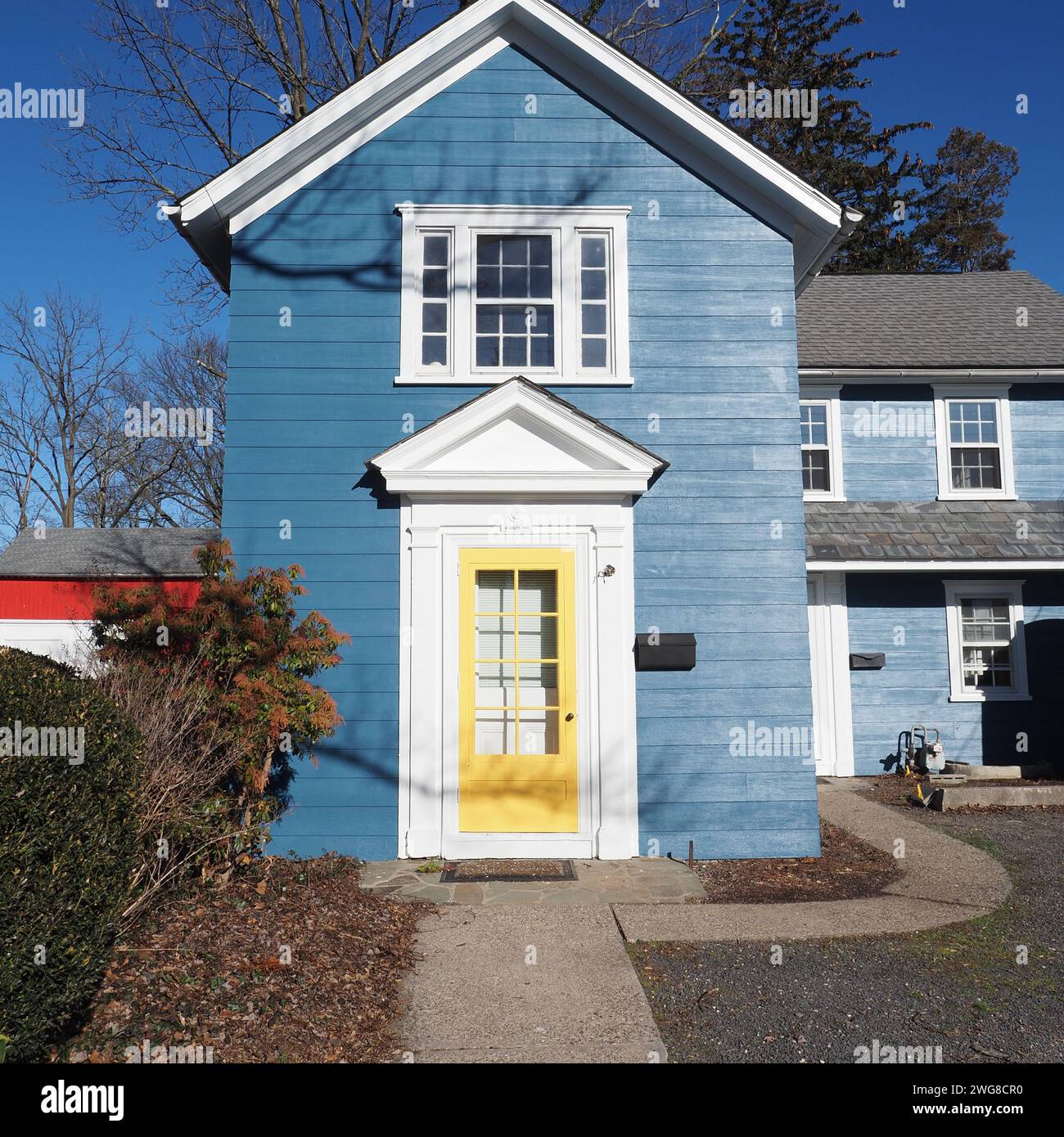 The blue house with a yellow door Stock Photo - Alamy