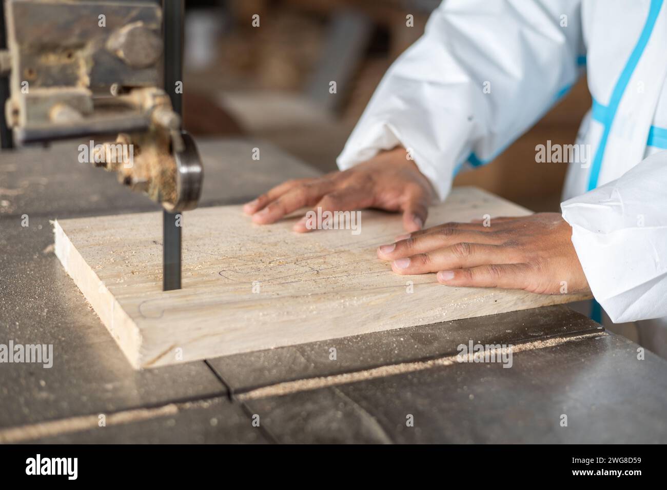 working with wood, hands of a person making a cut with a saw ...