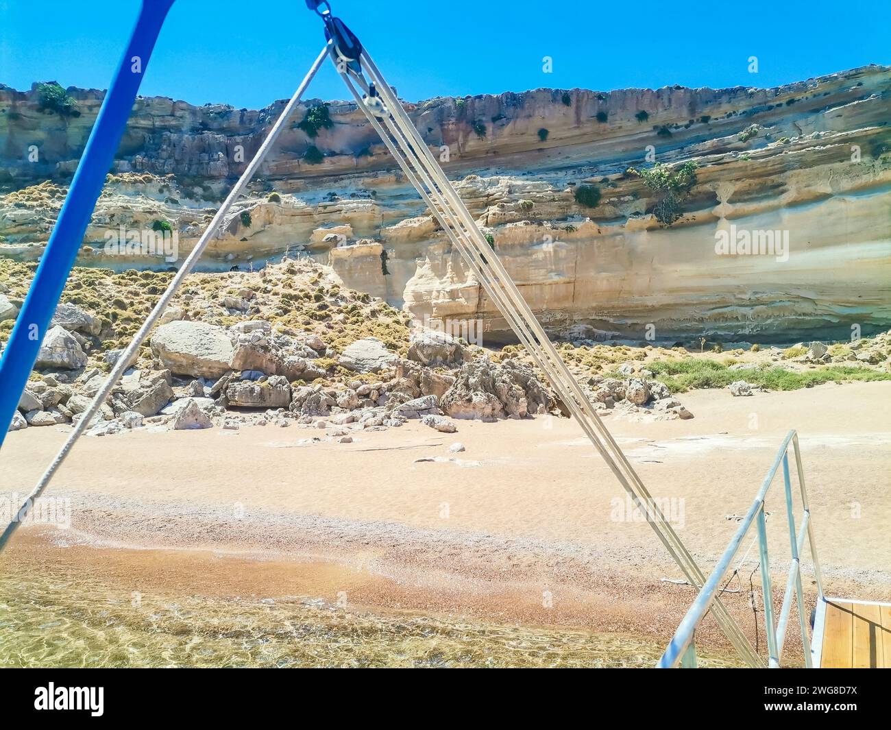 greek goat grazing on a rock with the sea and islands view in Rhodes ...