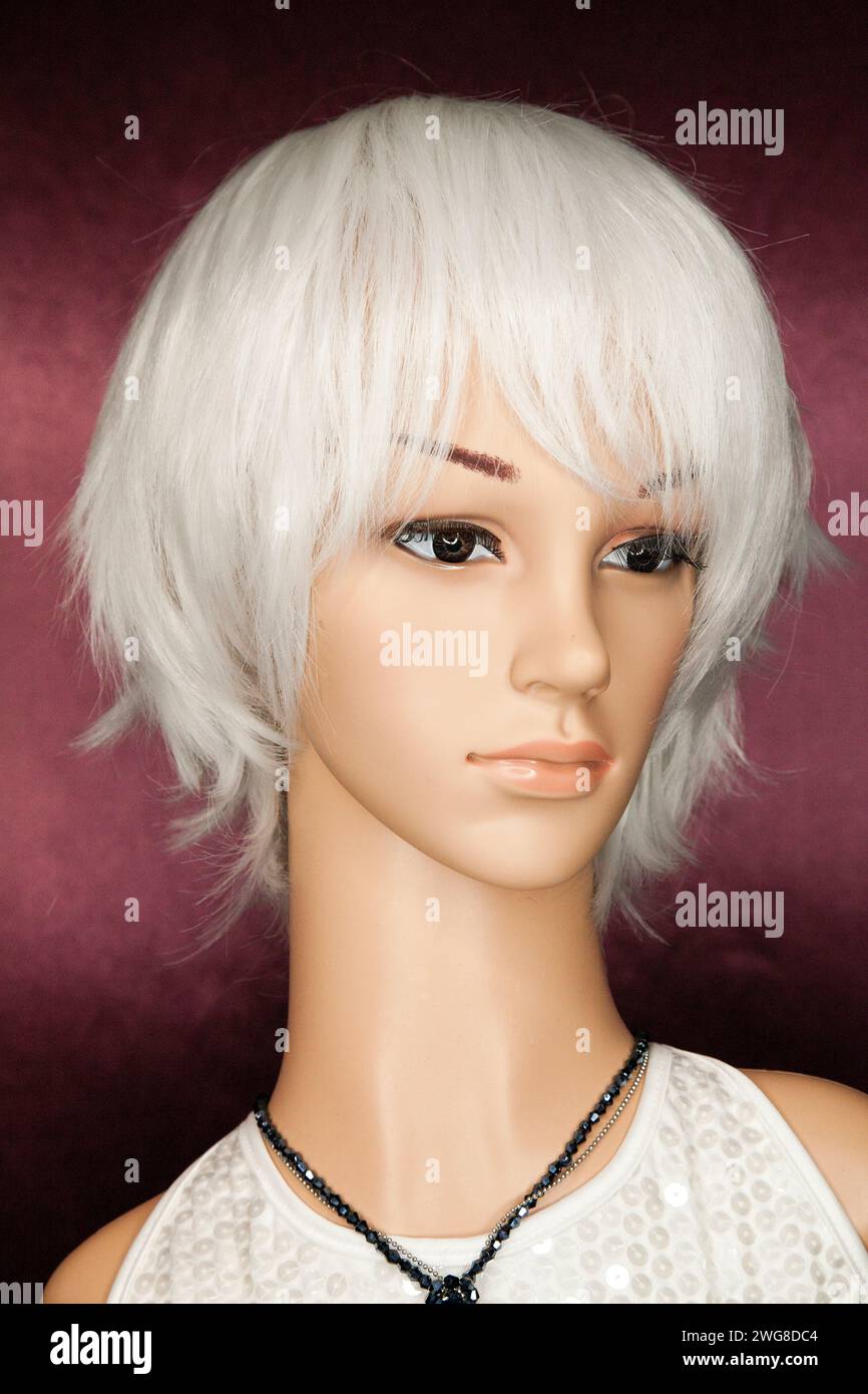 Plastic woman mannequin with short white hair and white tank top posing ...