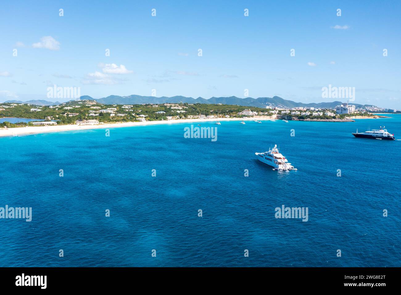 A fleet of boats sailing in a vast expanse of open blue ocean Stock ...