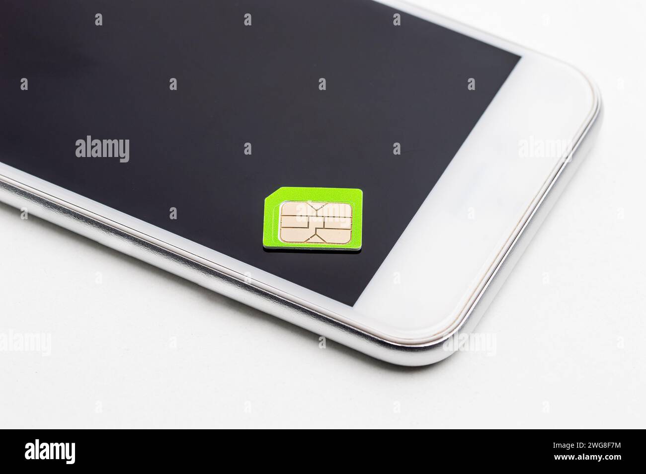 High angle shot of smart phone use with micro sim card with black ...