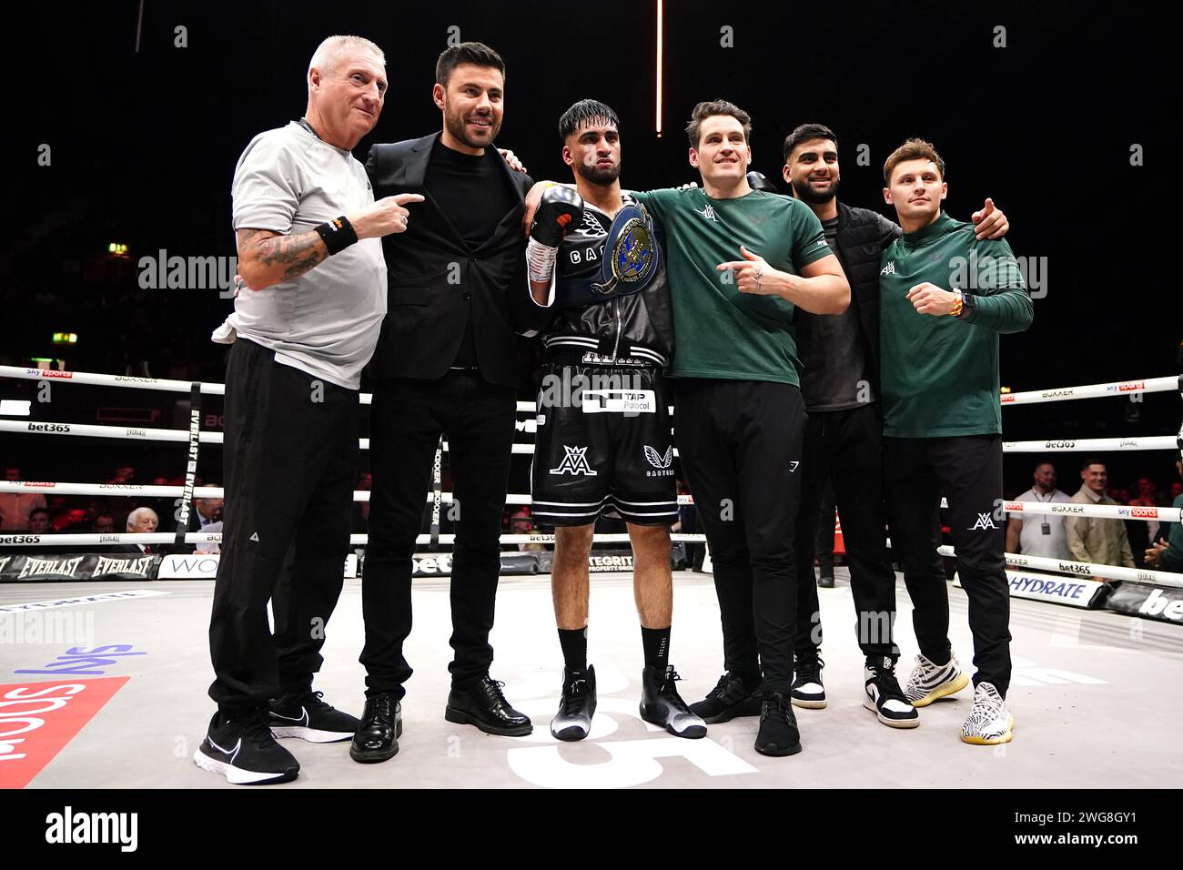 Adam Azim (third left) celebrates victory with his team and BOXXER Ceo ...