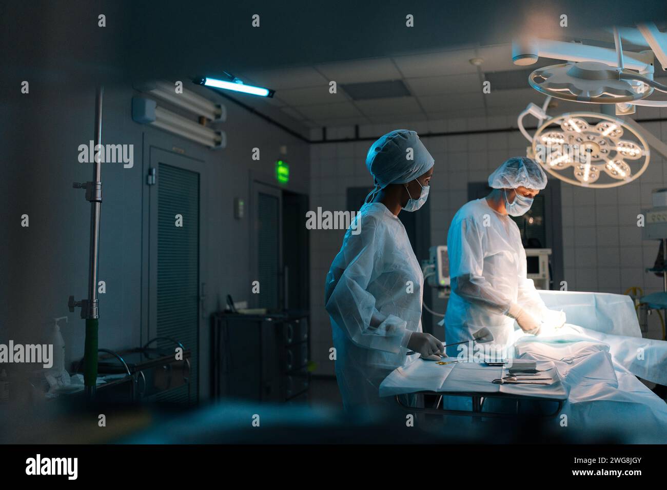 Remote view of male surgeon and African-American female nurse ...