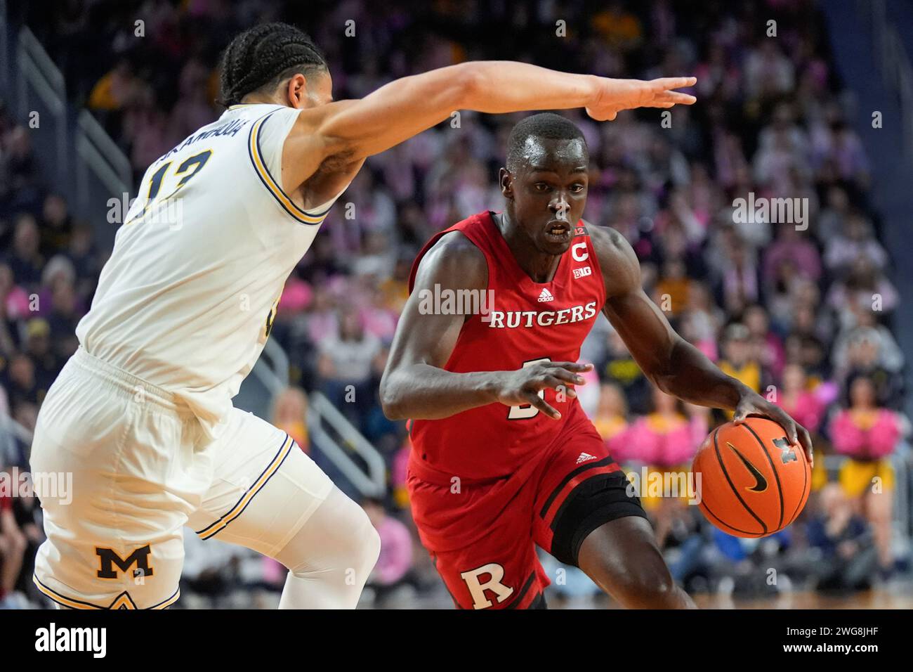 Rutgers forward Mawot Mag (3) drives on Michigan forward Olivier ...