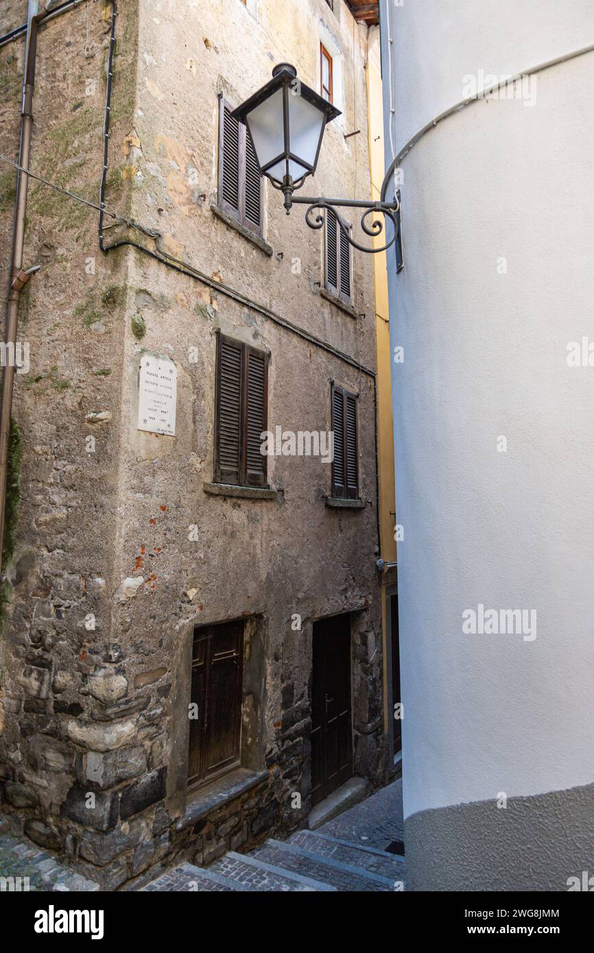 Steps lead to a small passageway between an ancient building and a ...