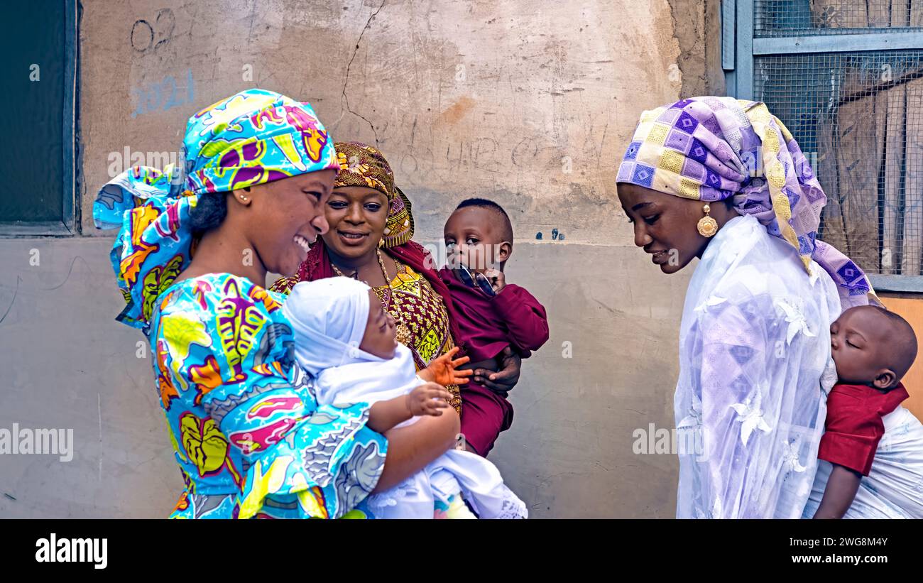 Three Muslim women with babies homes Accra Ghana. Poverty stricken ...