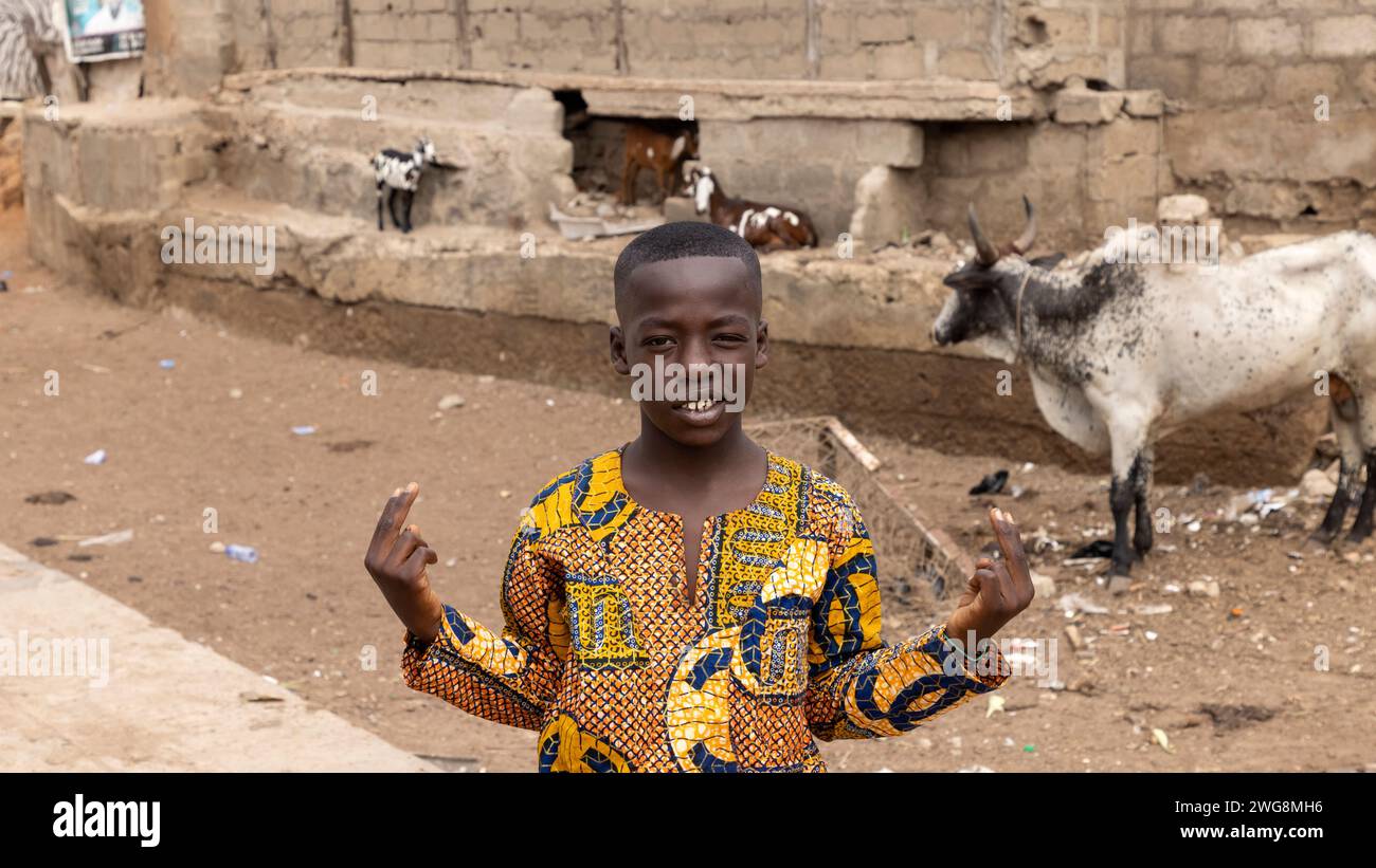 Young boy cow Nima Accra Ghana Muslim neighborhood. Poverty stricken ...