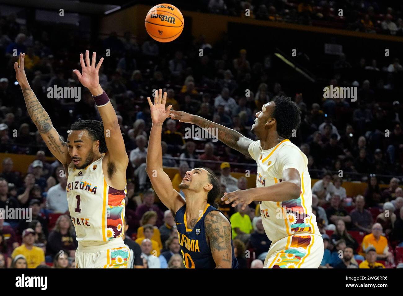 California guard Jaylon Tyson, center, has his shot blocked by Arizona ...