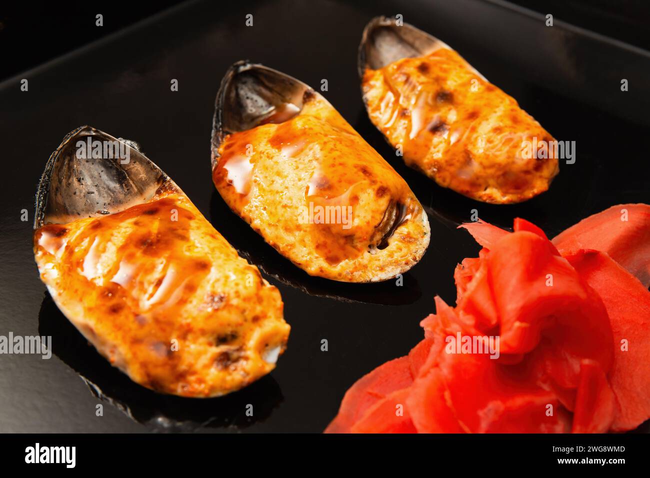 New Zealand Kiwi mussels topped with a rich blend of spicy mayo and ...