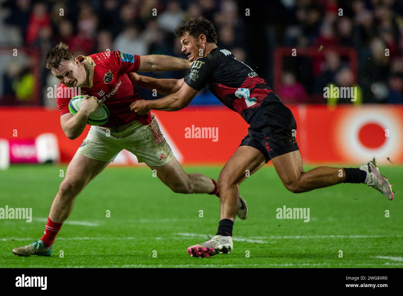 Sean O'Brien of Munster tackled by Macca Springer of Crusaders during ...