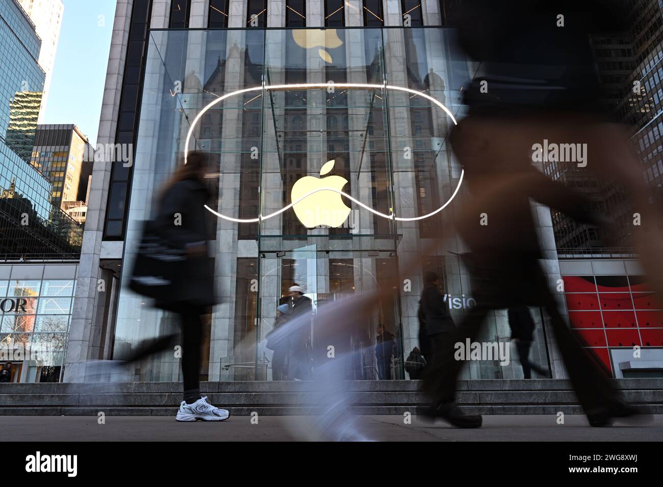 People walk past the Apple Fifth Avenue store in New York City. The ...