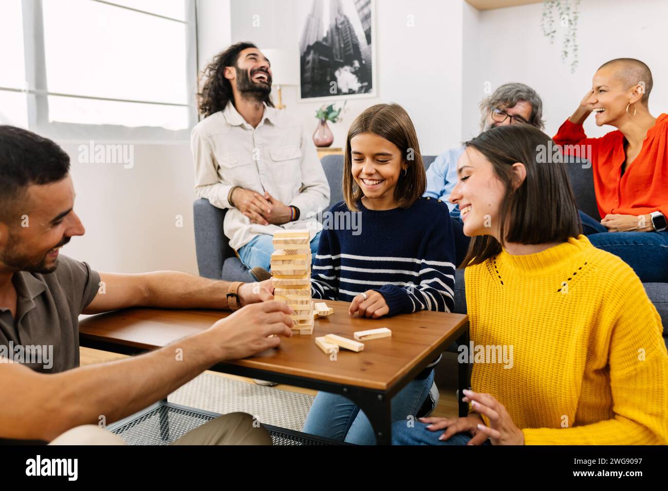 Multi-generational family having fun playing block game at home Stock ...