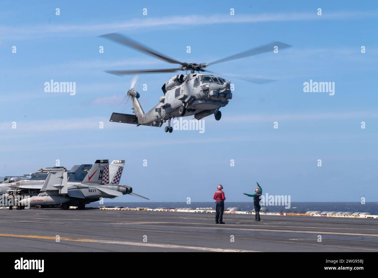 PACIFIC OCEAN (Jan. 30, 2024) An MH-60R Sea Hawk, attached to the “Wolf ...