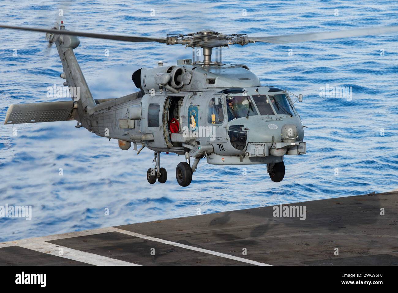 PACIFIC OCEAN (Jan. 25, 2024) An MH-60R Sea Hawk, assigned to the “Wolf ...