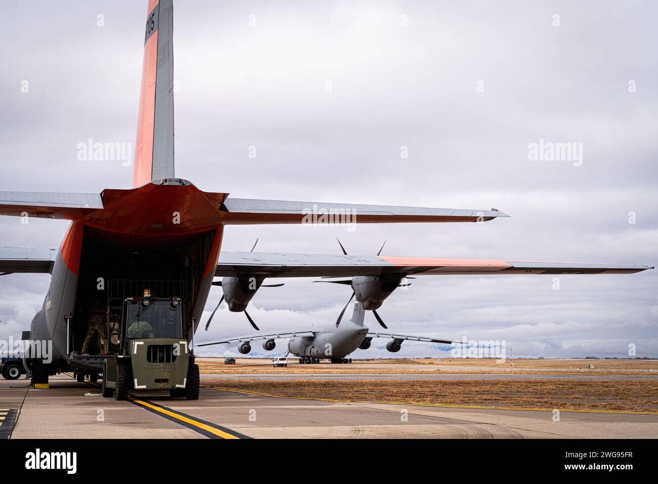 U.S. Airmen with the 139th Aerial Port Flight, load a mass container ...