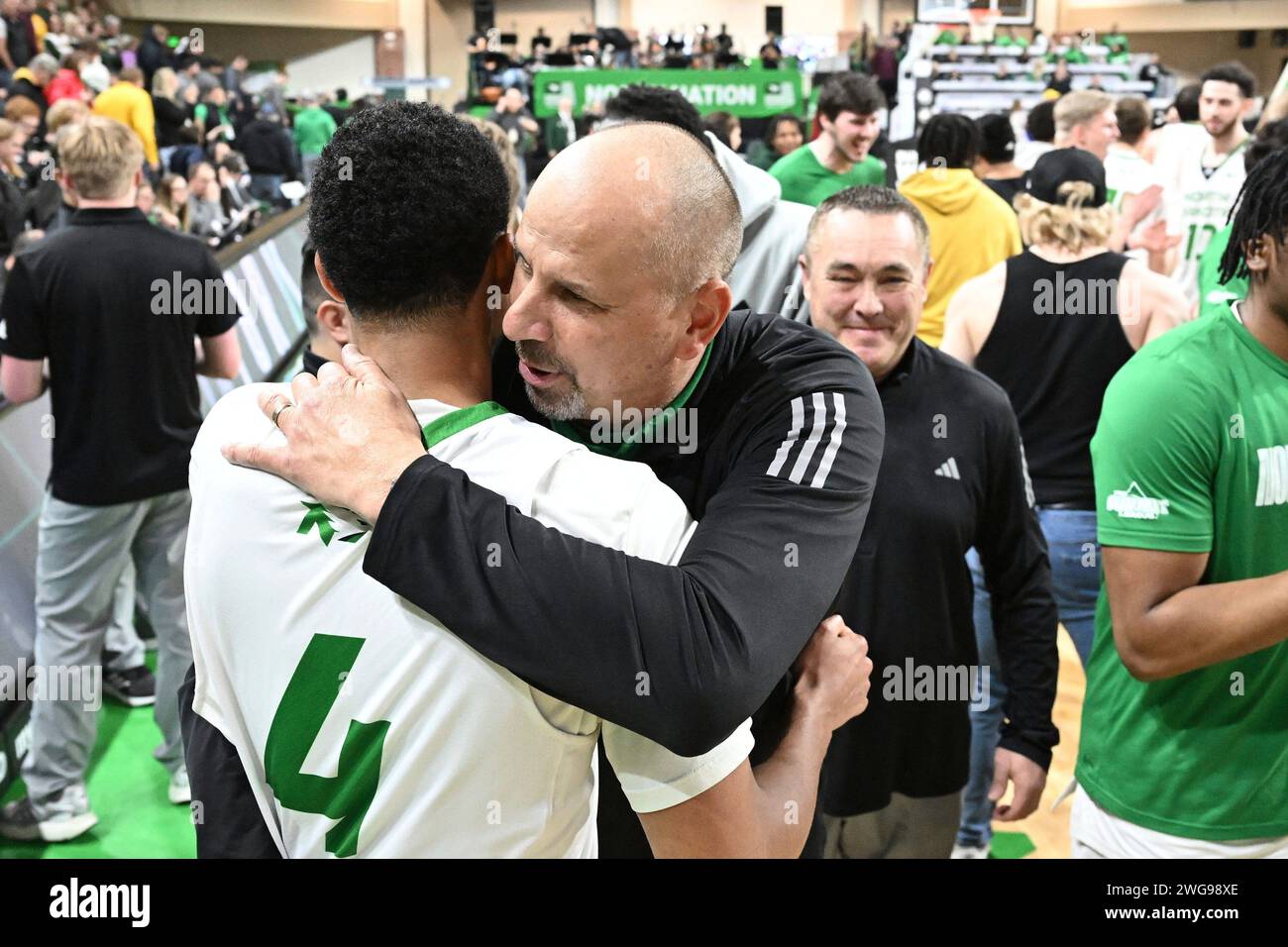 North Dakota Fighting Hawks head coach Paul Sather hugs .North Dakota ...