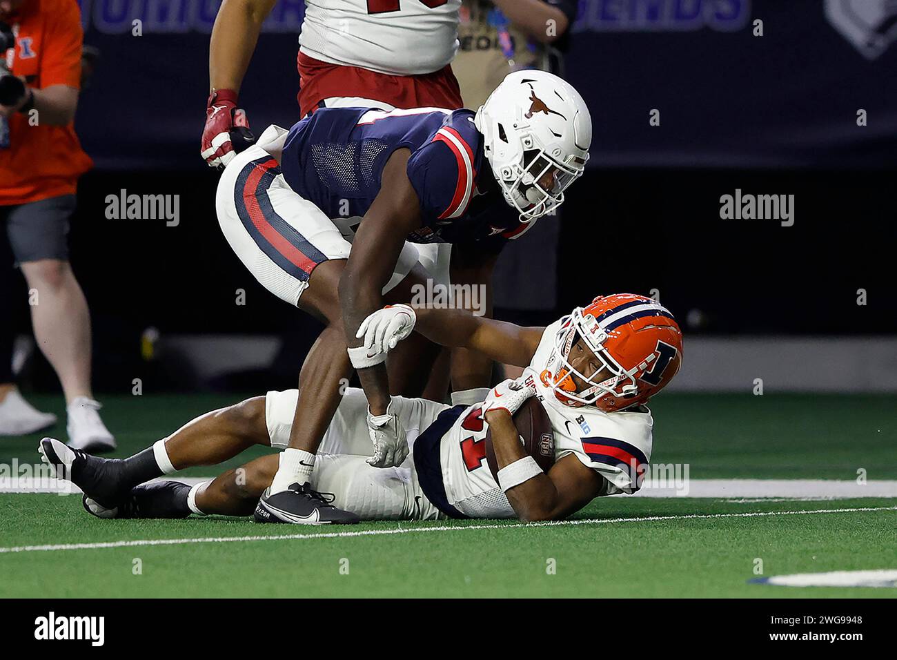 West safety Ryan Watts (top) of Texas gets up after tackling East ...