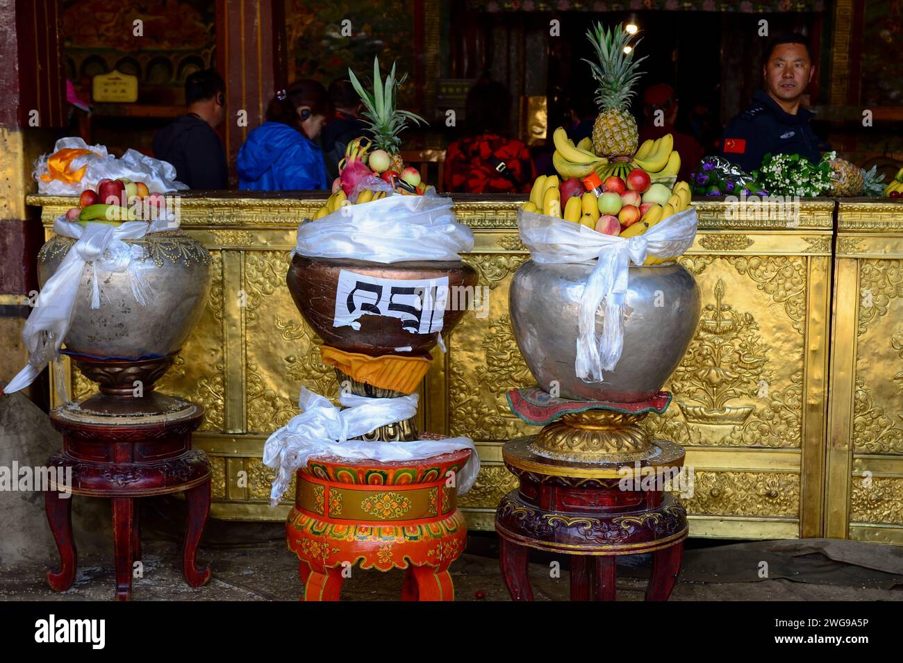 A fruit stand vendor sells his wares outside the Jokhang Temple in ...