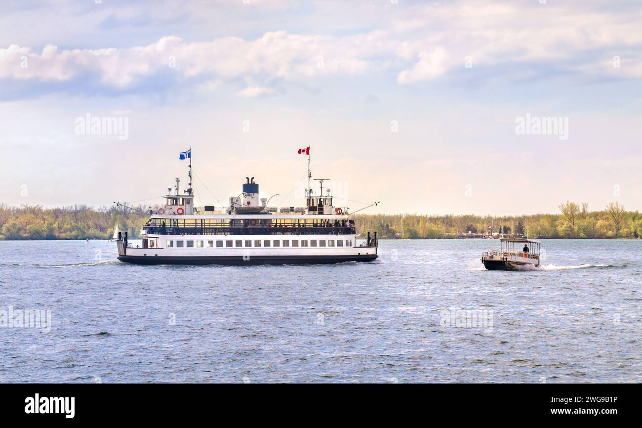 Historic Grandfather Toronto Ferry boat and a small water taxi boat ...
