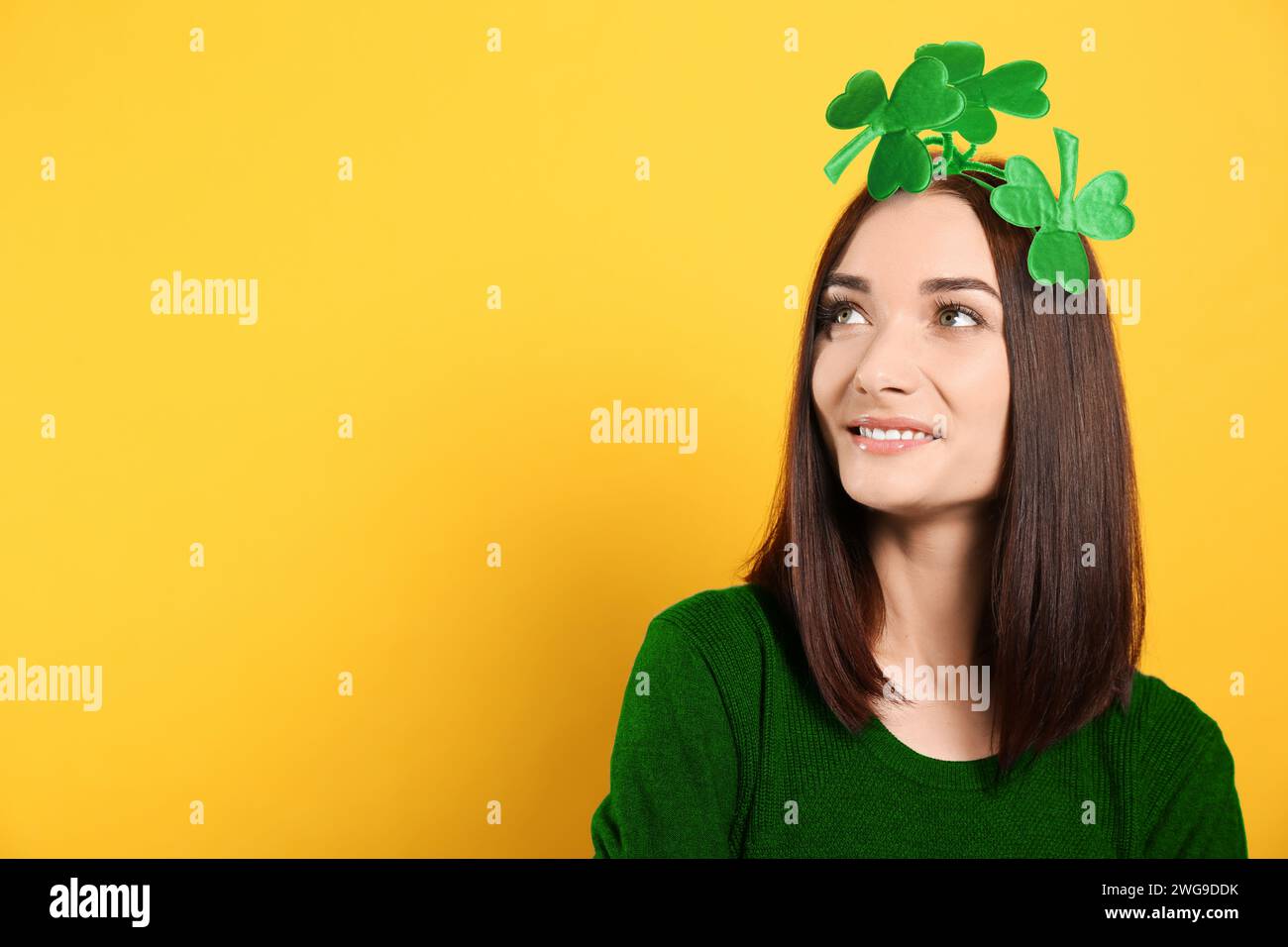 St. Patrick's day party. Pretty woman with green clover headband on ...