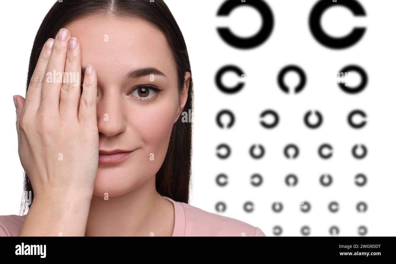 Vision test. Young woman and eye chart on white background Stock Photo ...
