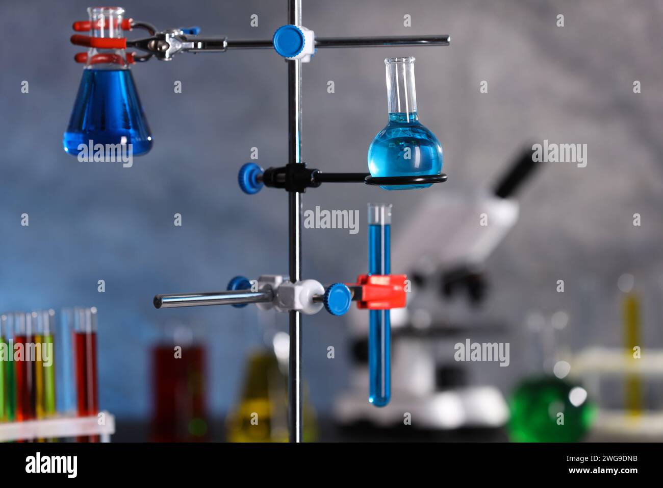 Laboratory glassware with blue liquid on retort stand indoors Stock ...