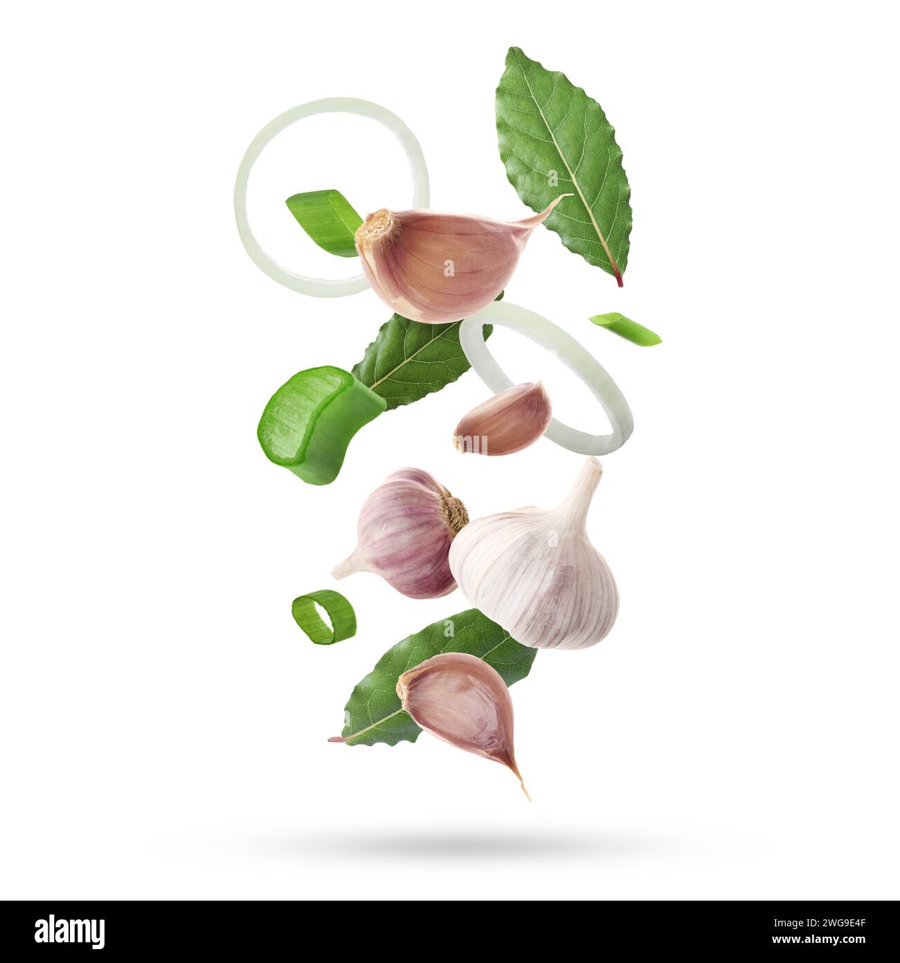 Different aromatic spices falling on white background Stock Photo - Alamy