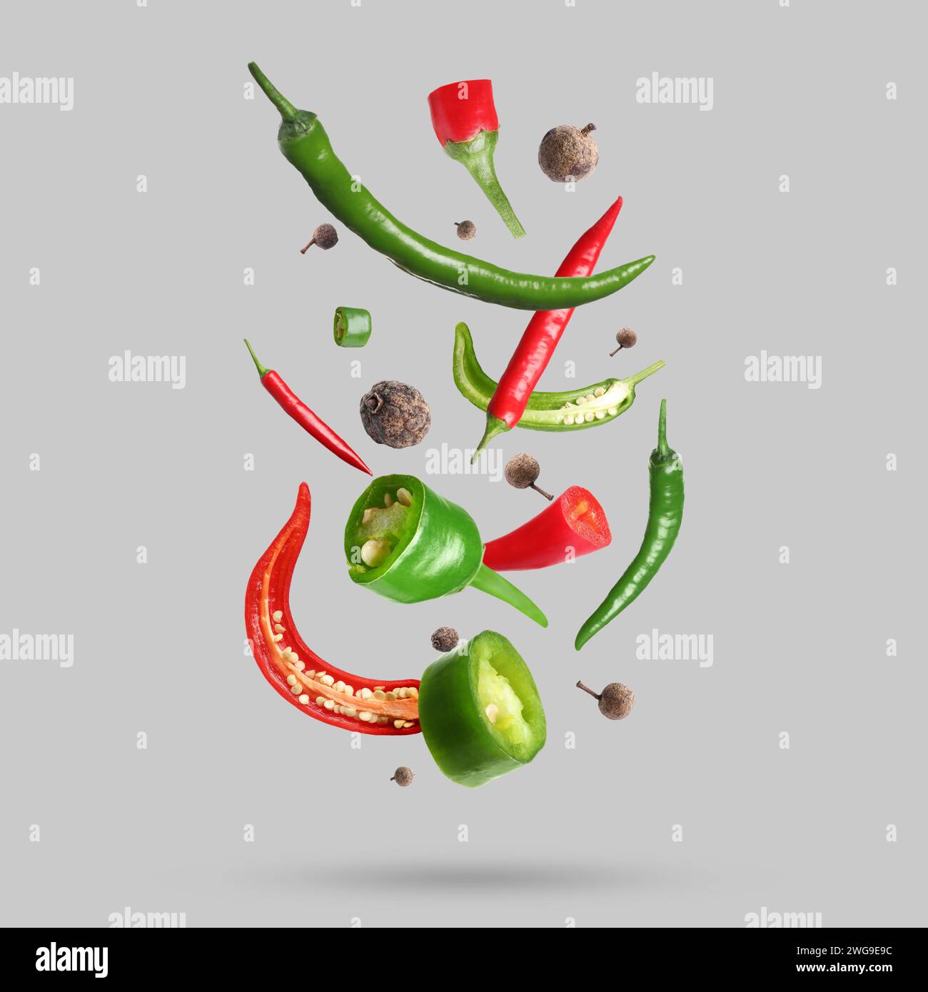 Different spices falling on light grey background Stock Photo - Alamy