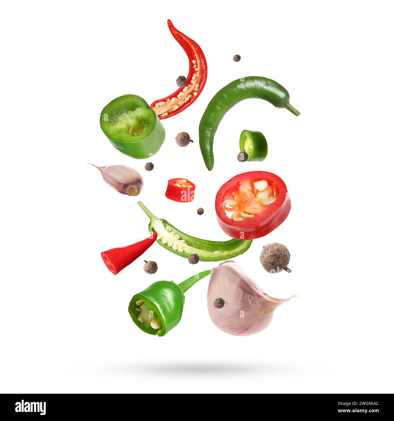 Different aromatic spices falling on white background Stock Photo - Alamy