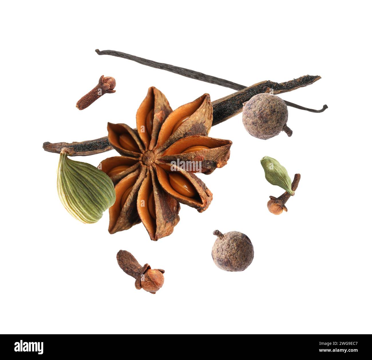 Different aromatic spices falling on white background Stock Photo - Alamy