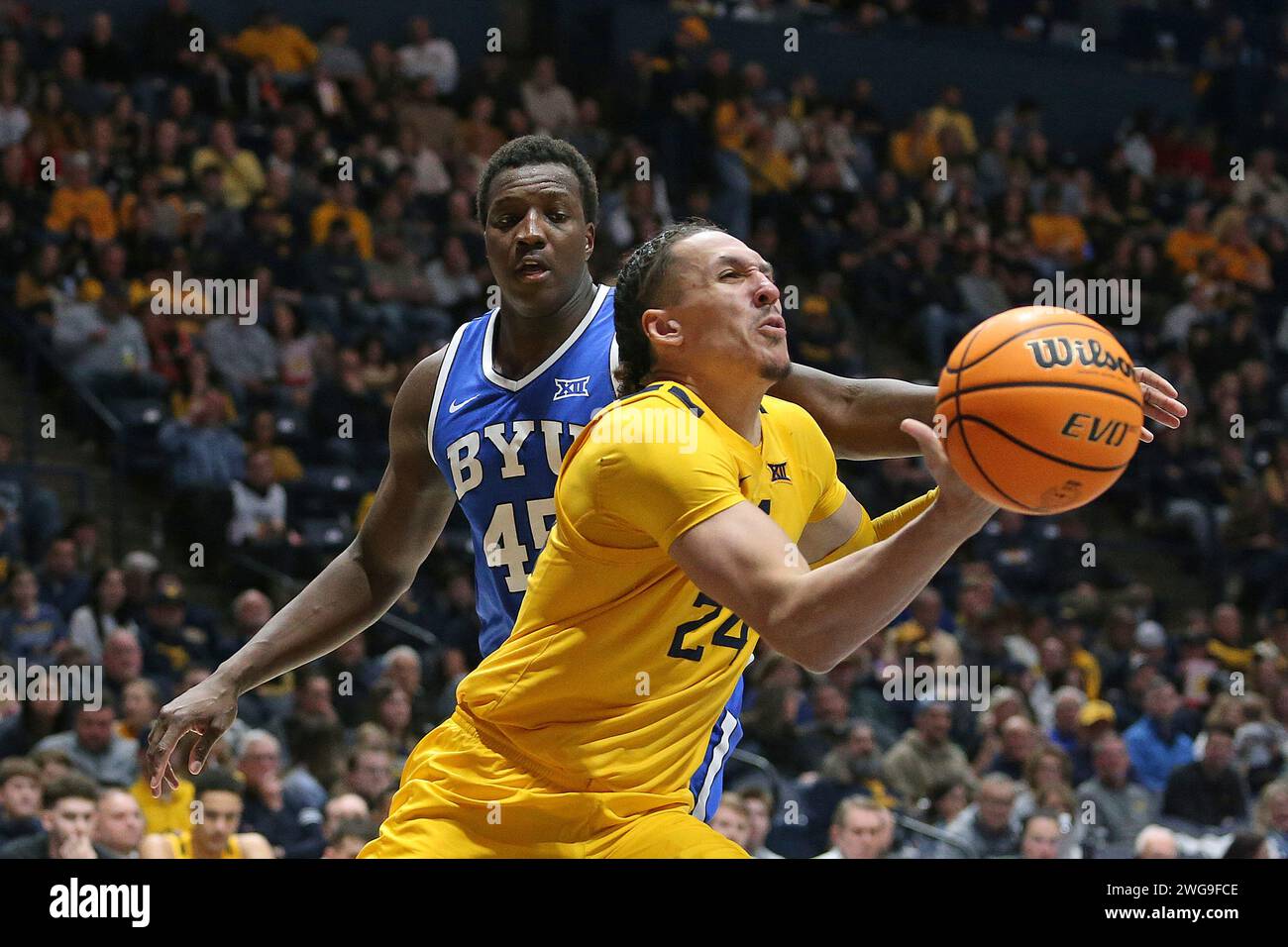West Virginia forward Patrick Suemnick (24) Is defended by BYU forward ...