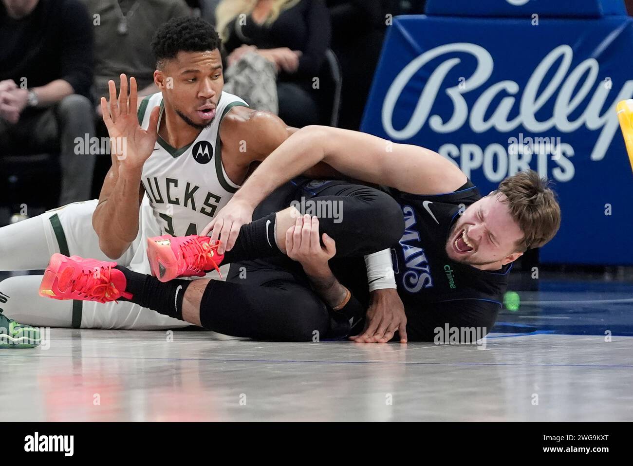 Dallas Mavericks guard Luka Doncic, right, reacts after getting tangled ...