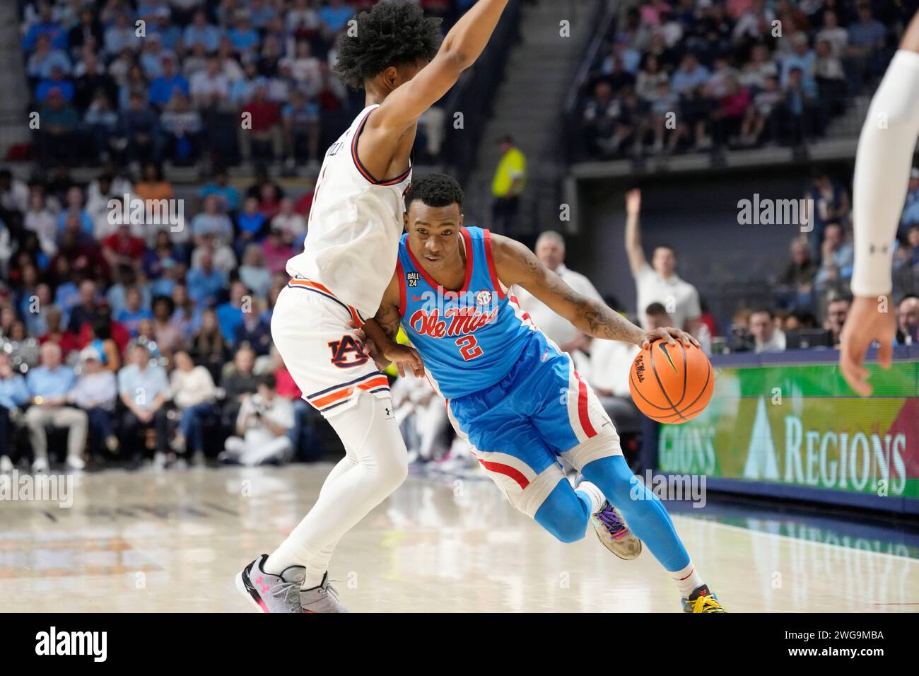 Mississippi guard TJ Caldwell (2) tries to shoulder past Auburn guard ...
