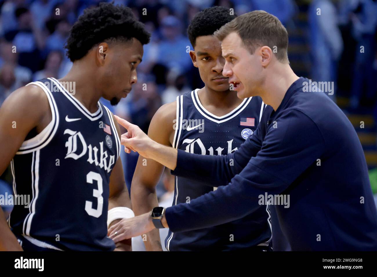 Duke head coach Jon Scheyer, right, gives direction to guards Jeremy ...