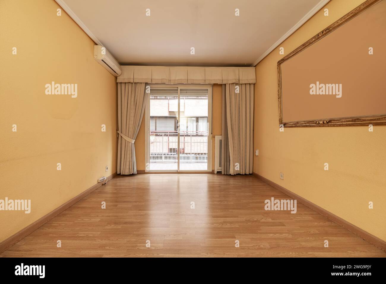 Empty room with walls painted a soft cream color, plaster moldings on ...