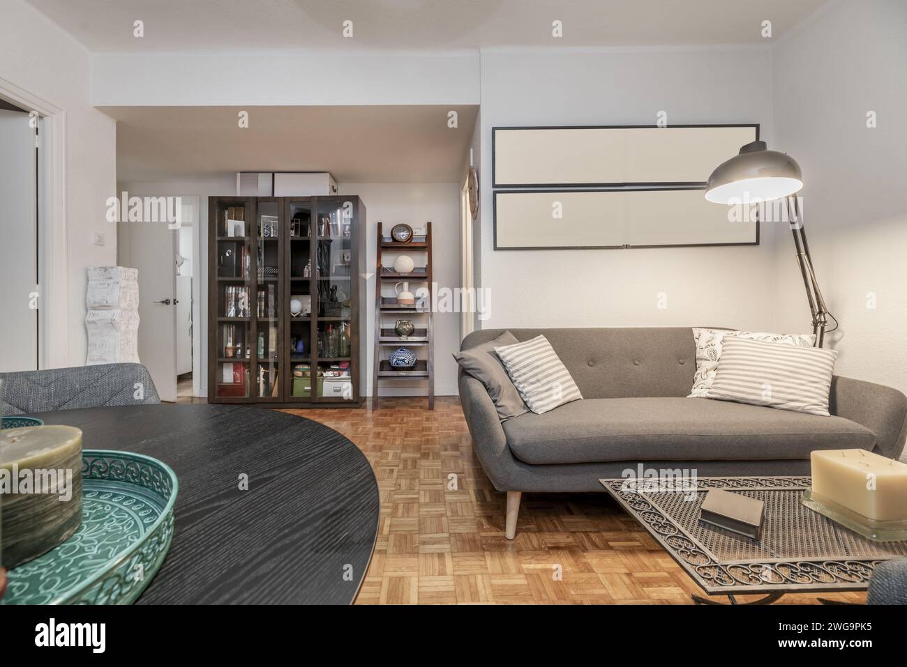 Living room of a house furnished with a gray fabric divan sofa, a ...