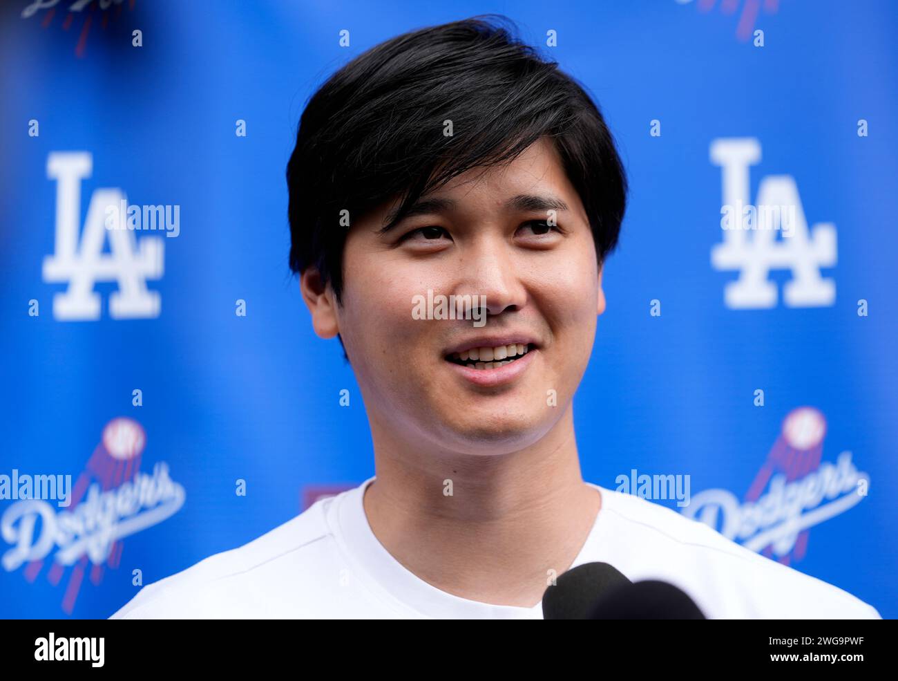 Los Angeles Dodgers' Shohei Ohtani smiles while talking to the media at ...