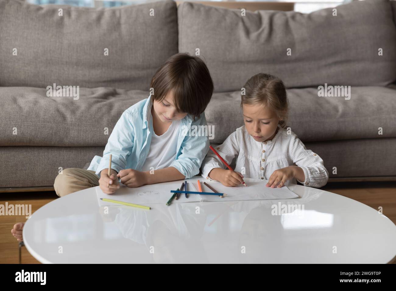 Little kids drawing pictures in sketchbook with colored pencils Stock ...